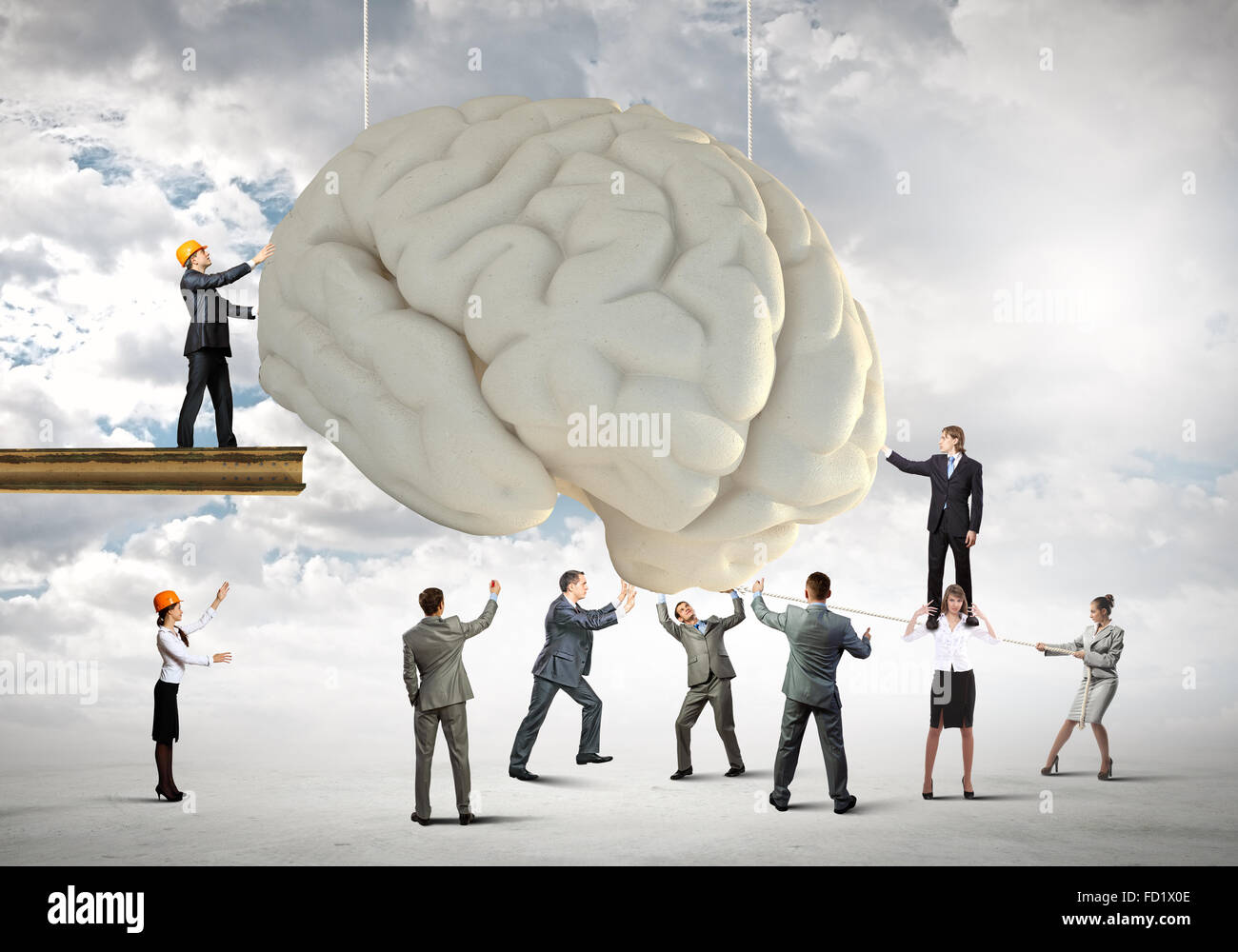 Huge human brain and many little businesspeople around Stock Photo - Alamy