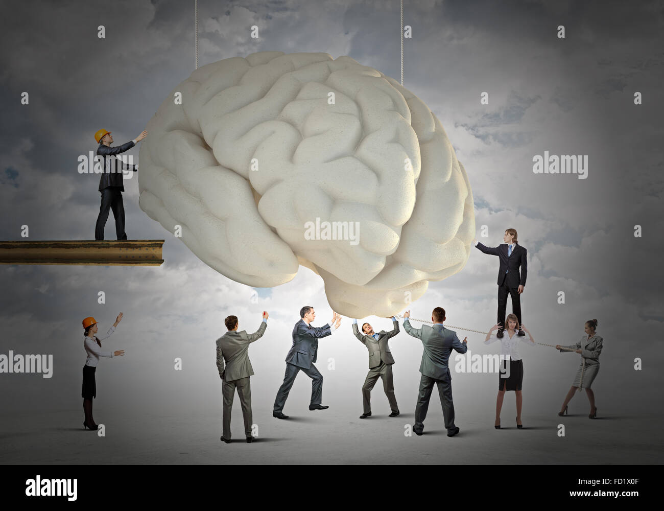Huge human brain and many little businesspeople around Stock Photo - Alamy