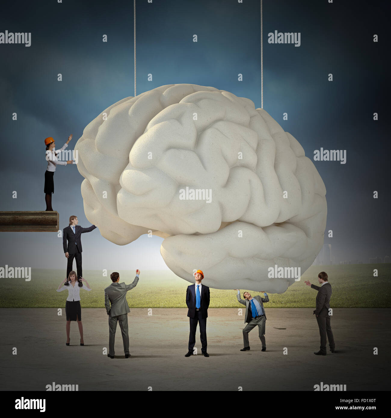 Huge human brain and many little businesspeople around Stock Photo - Alamy