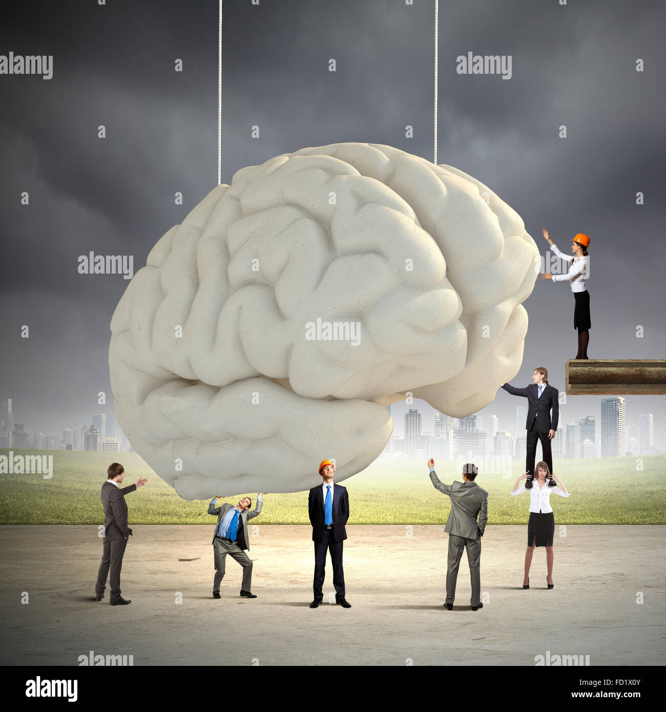 Huge human brain and many little businesspeople around Stock Photo - Alamy