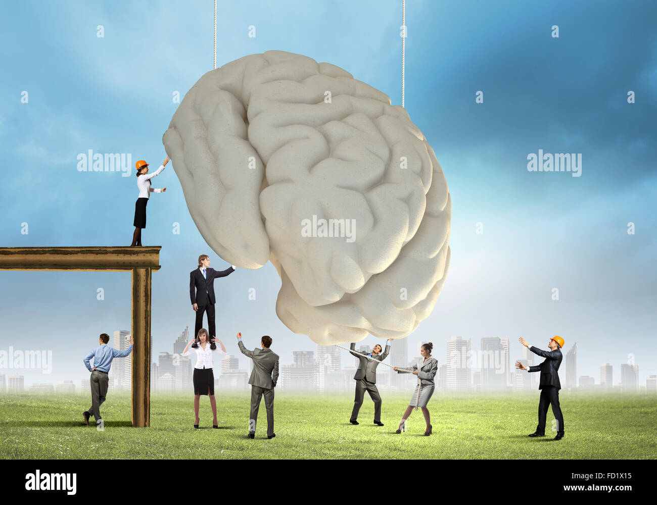 Huge human brain and many little businesspeople around Stock Photo - Alamy