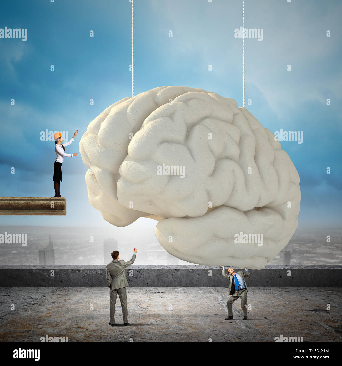 Huge human brain and many little businesspeople around Stock Photo - Alamy