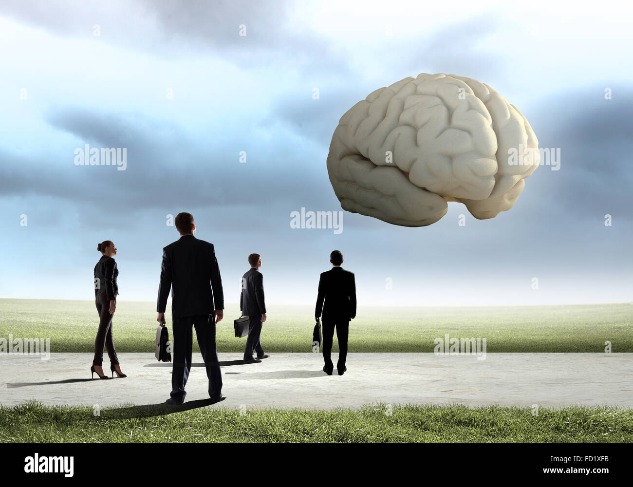Huge human brain and many little businesspeople around Stock Photo - Alamy