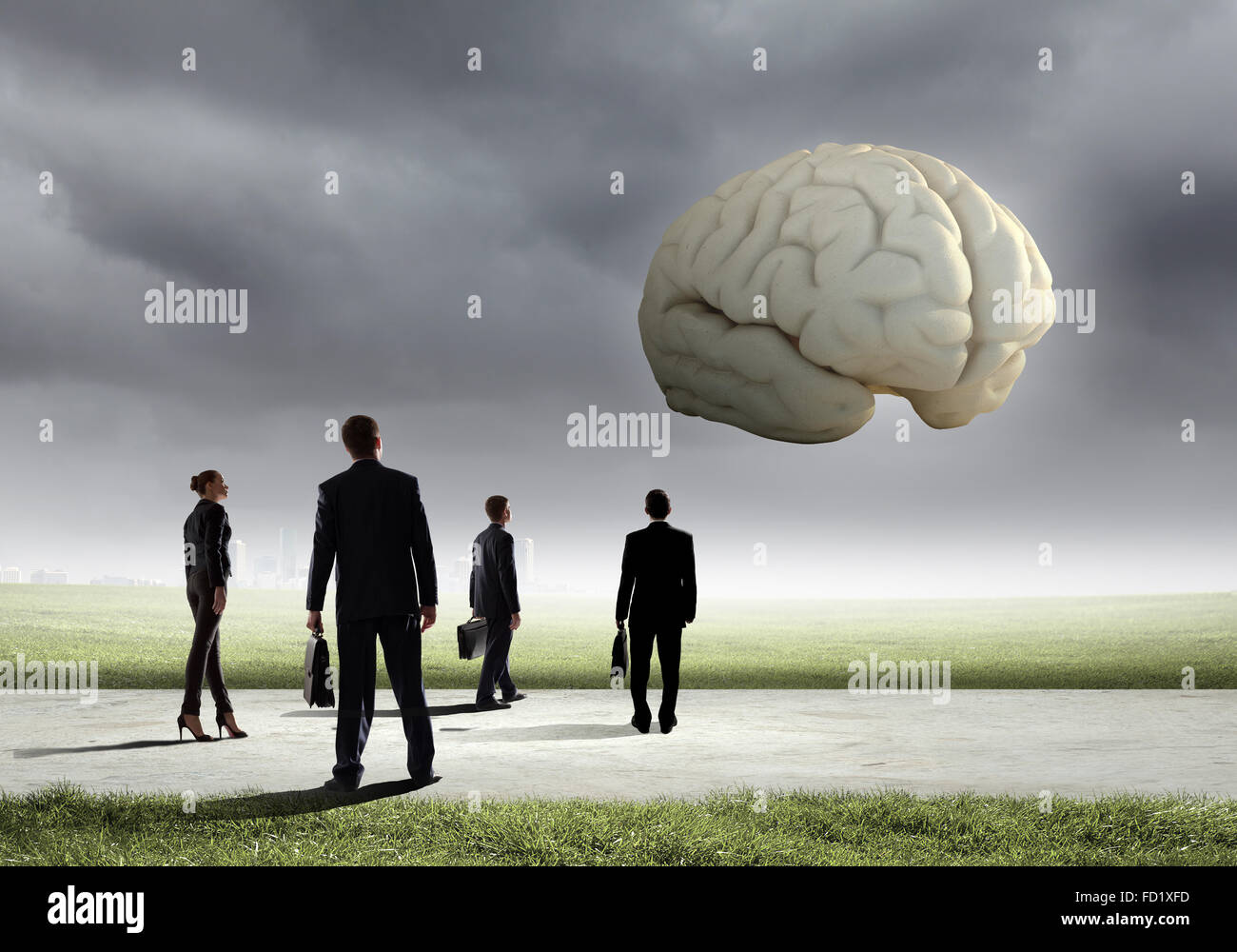 Huge human brain and many little businesspeople around Stock Photo - Alamy