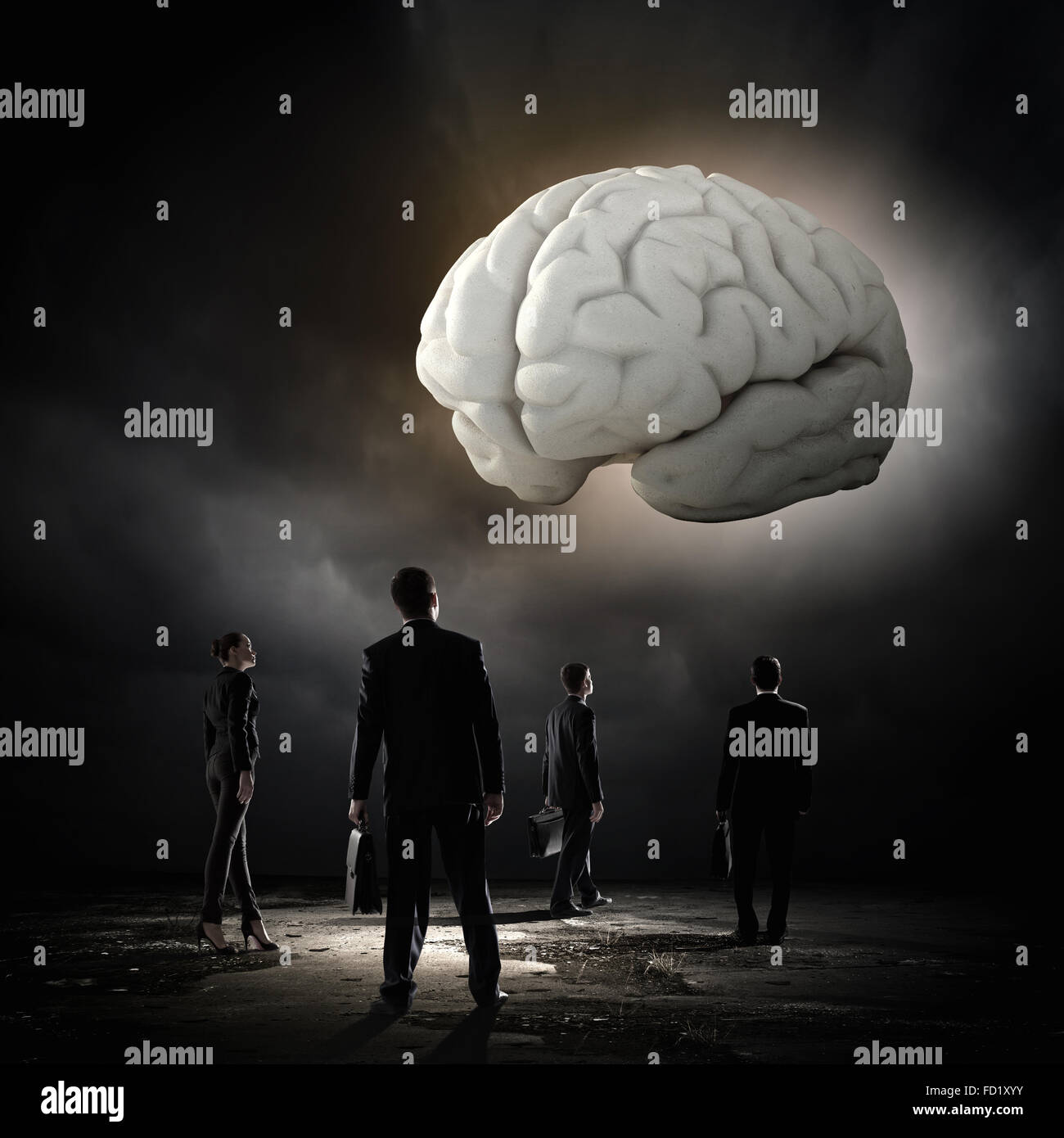 Huge human brain and many little businesspeople around Stock Photo - Alamy