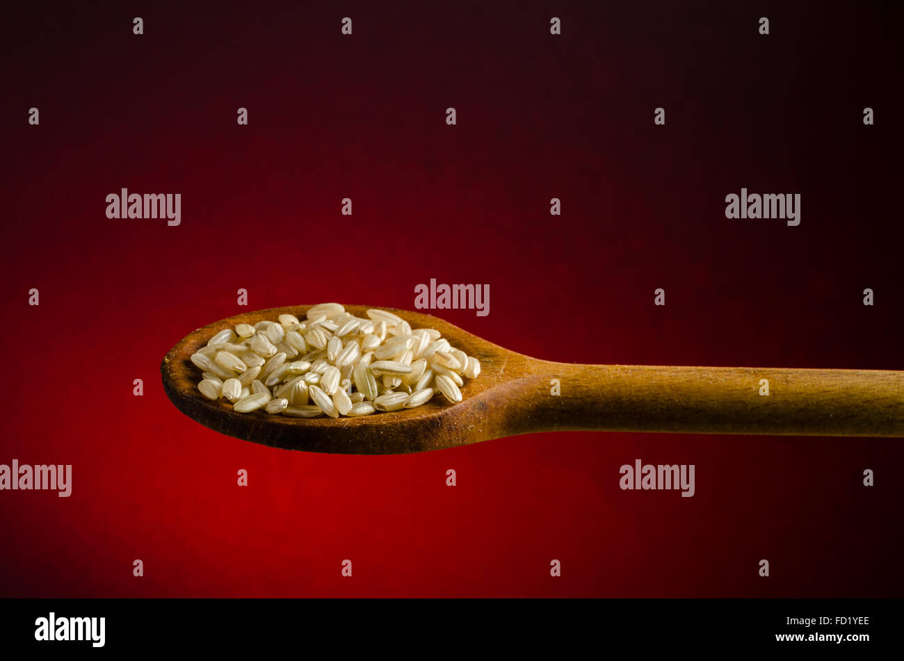 rice in a spoon, close up, color background Stock Photo - Alamy