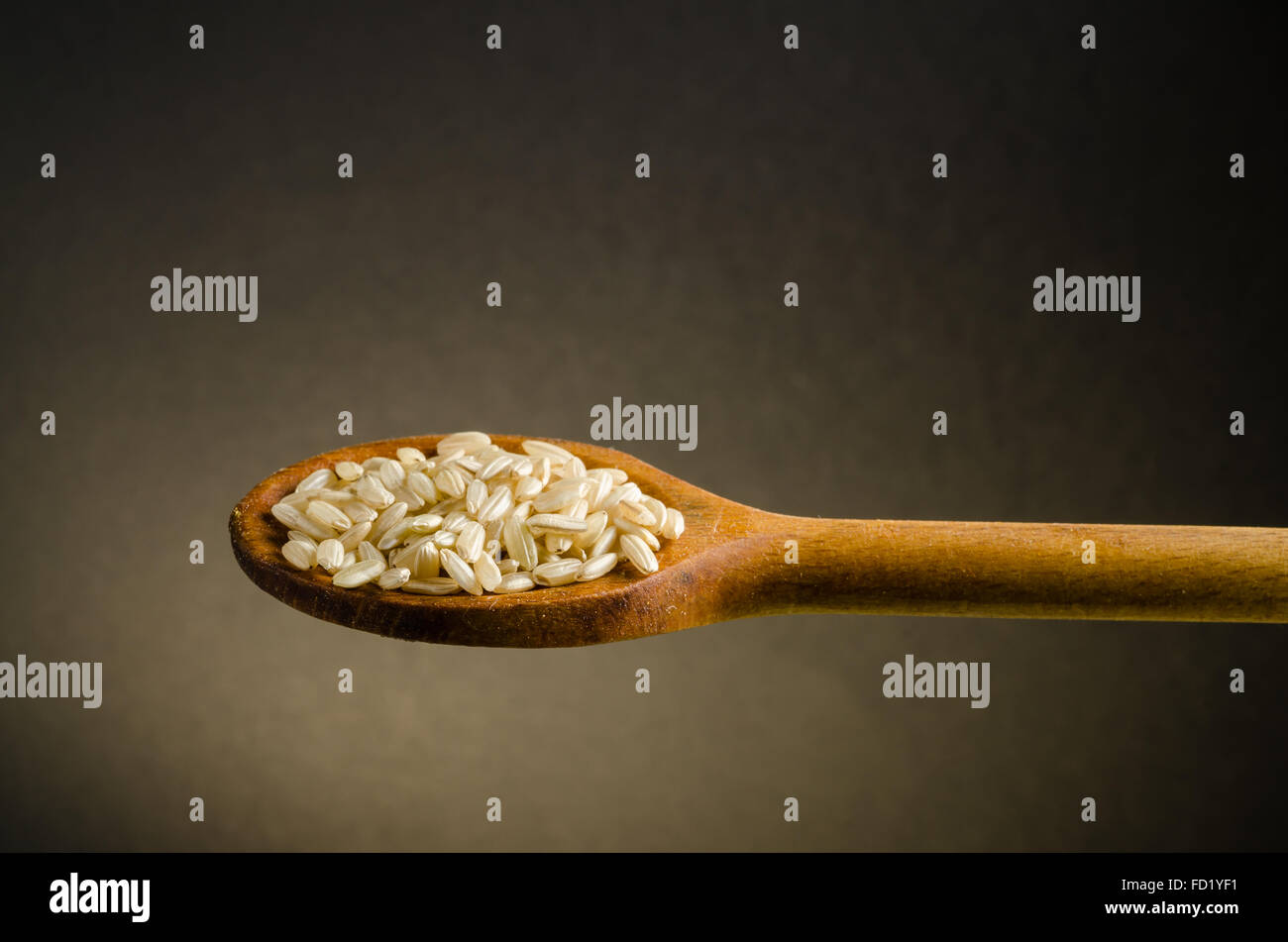rice in a spoon, close up, color background Stock Photo - Alamy