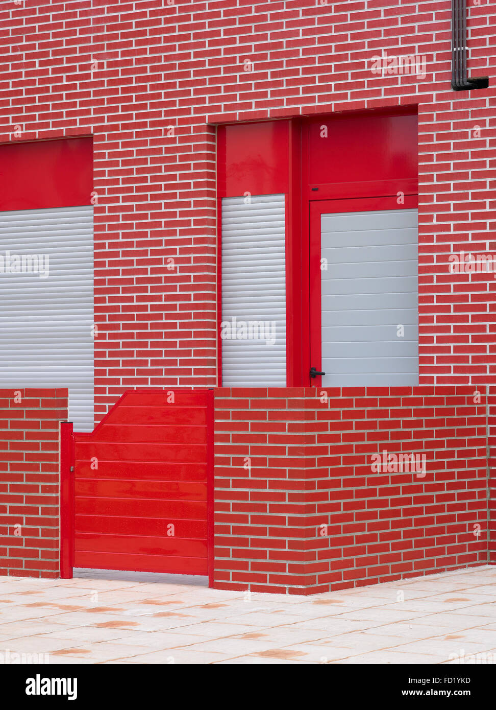 Red building facade with patio. Bricks. Vertical Stock Photo - Alamy
