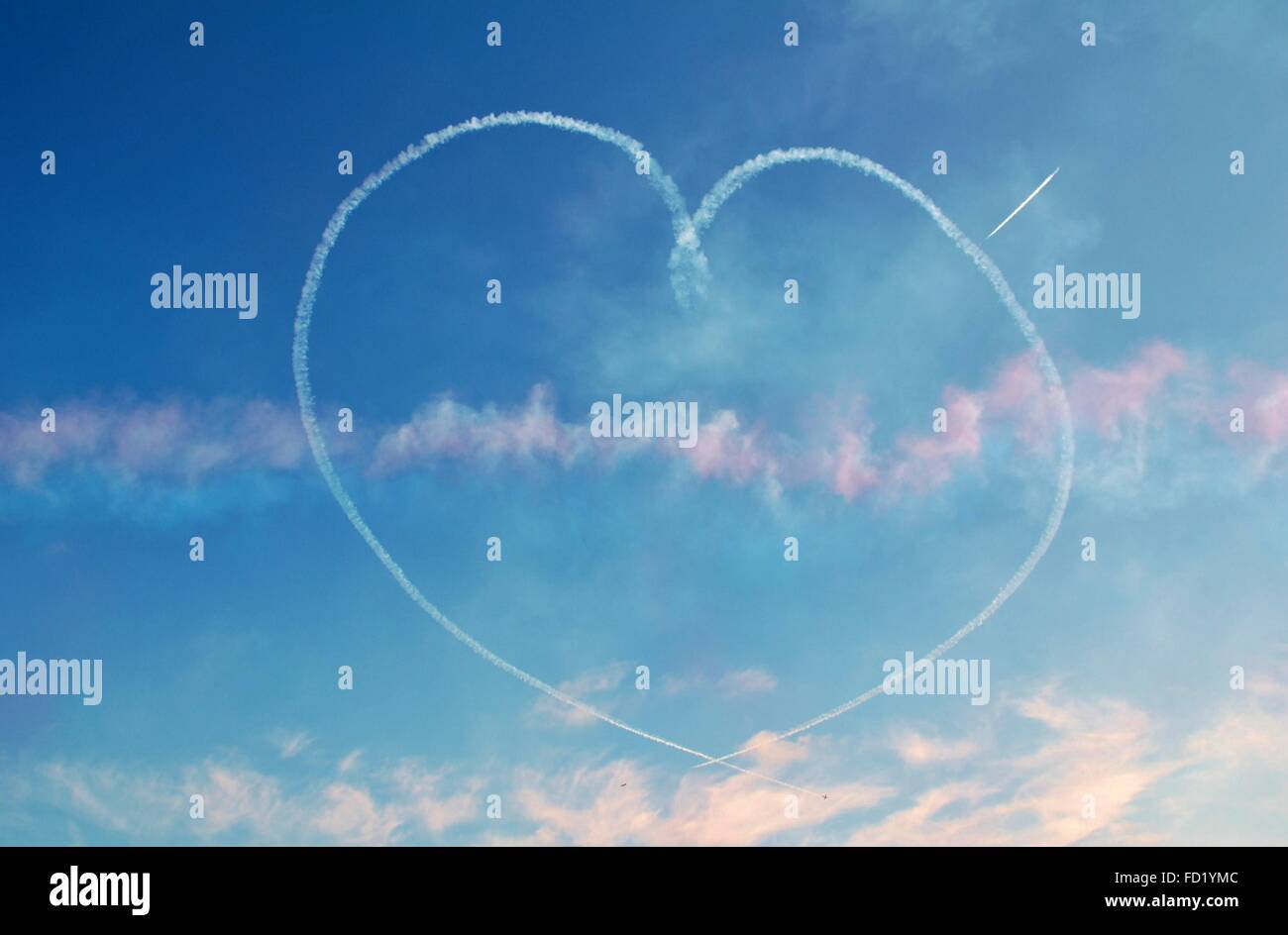 Jet planes create a heart shaped smoke trail in the sky Stock Photo - Alamy