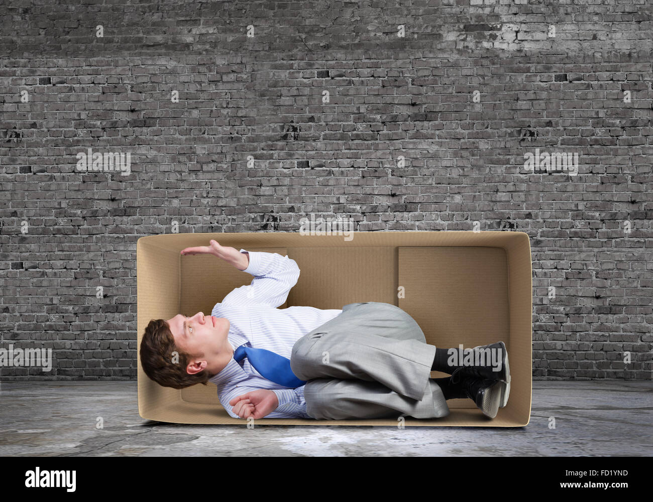 Young frustrated businessman trapped in small carton box Stock Photo ...