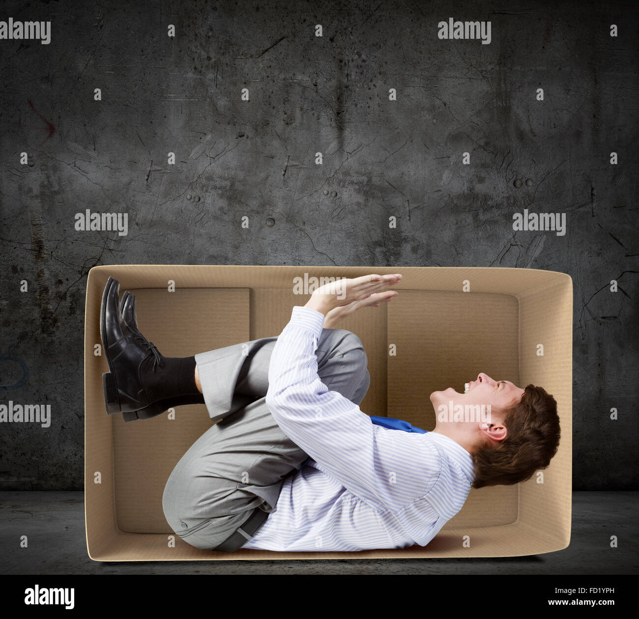 Young frustrated businessman trapped in small carton box Stock Photo ...