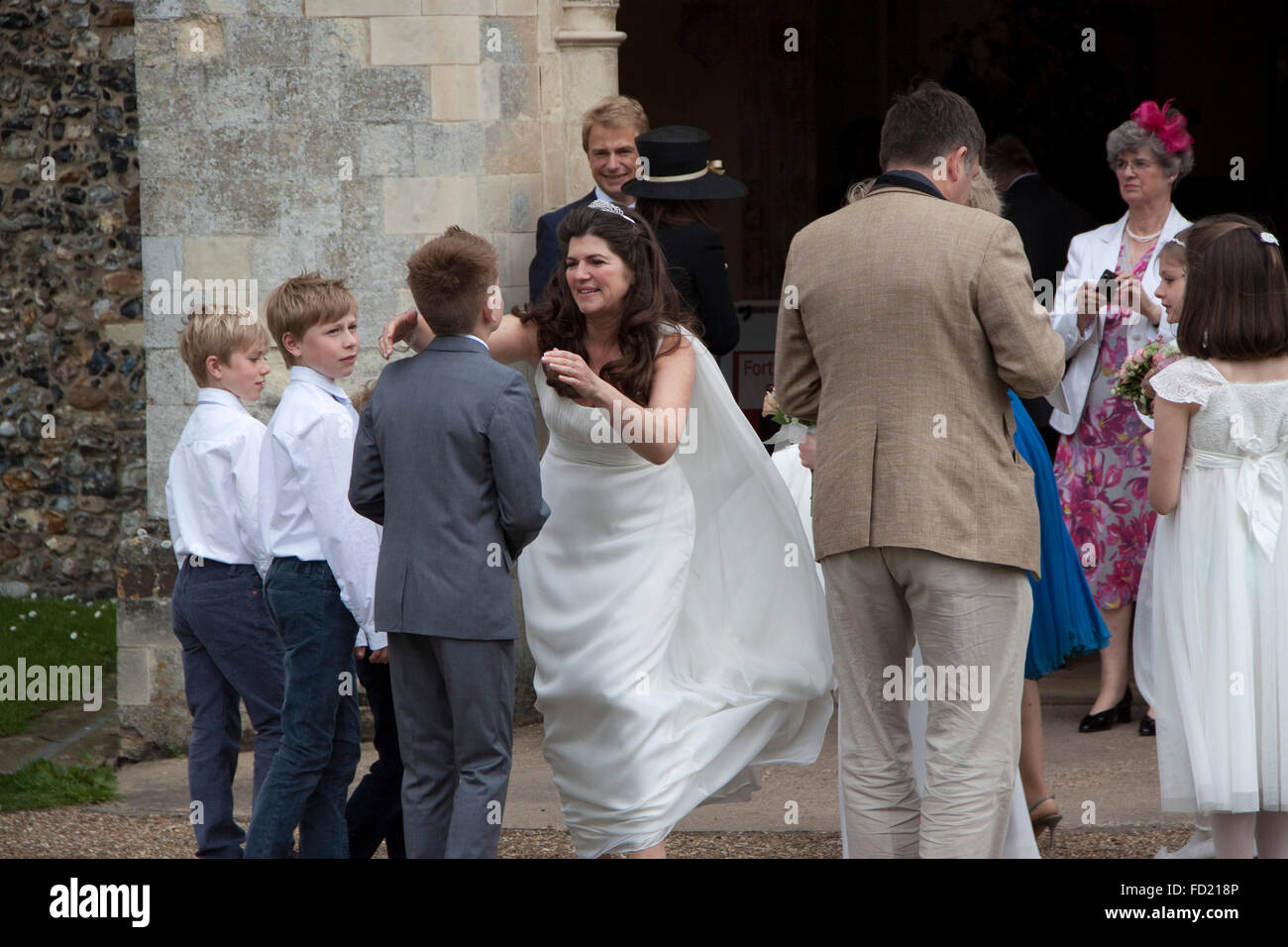 Newly married bride embraces young boy Stock Photo - Alamy