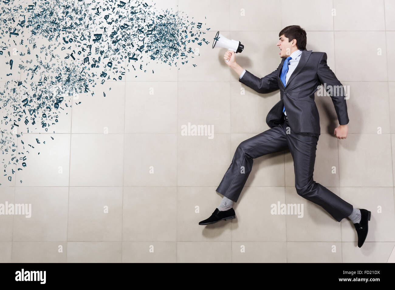 Young businessman running with megaphone in hand Stock Photo - Alamy