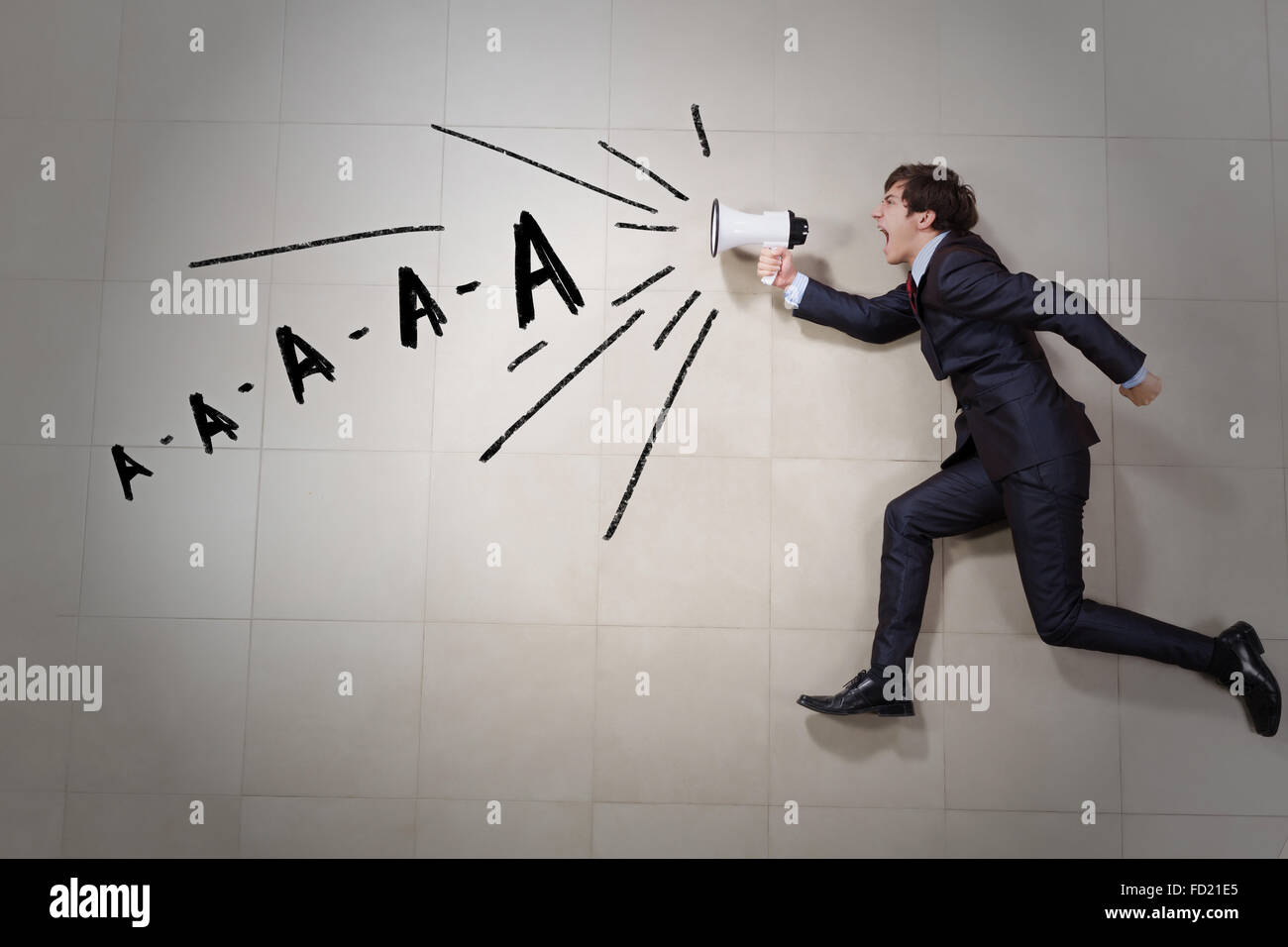 Young businessman running with megaphone in hand Stock Photo - Alamy