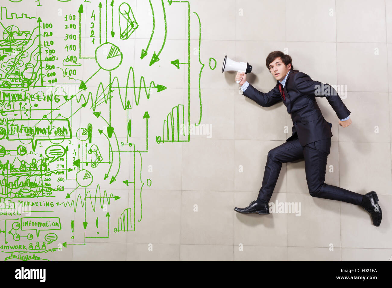 Young businessman running with megaphone in hand Stock Photo - Alamy