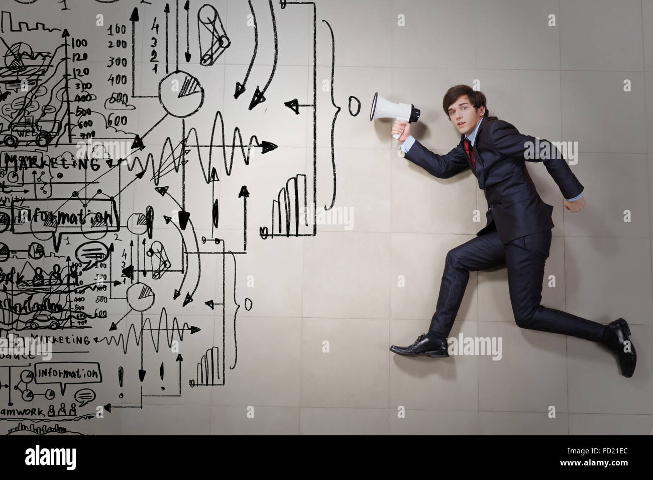 Young businessman running with megaphone in hand Stock Photo - Alamy