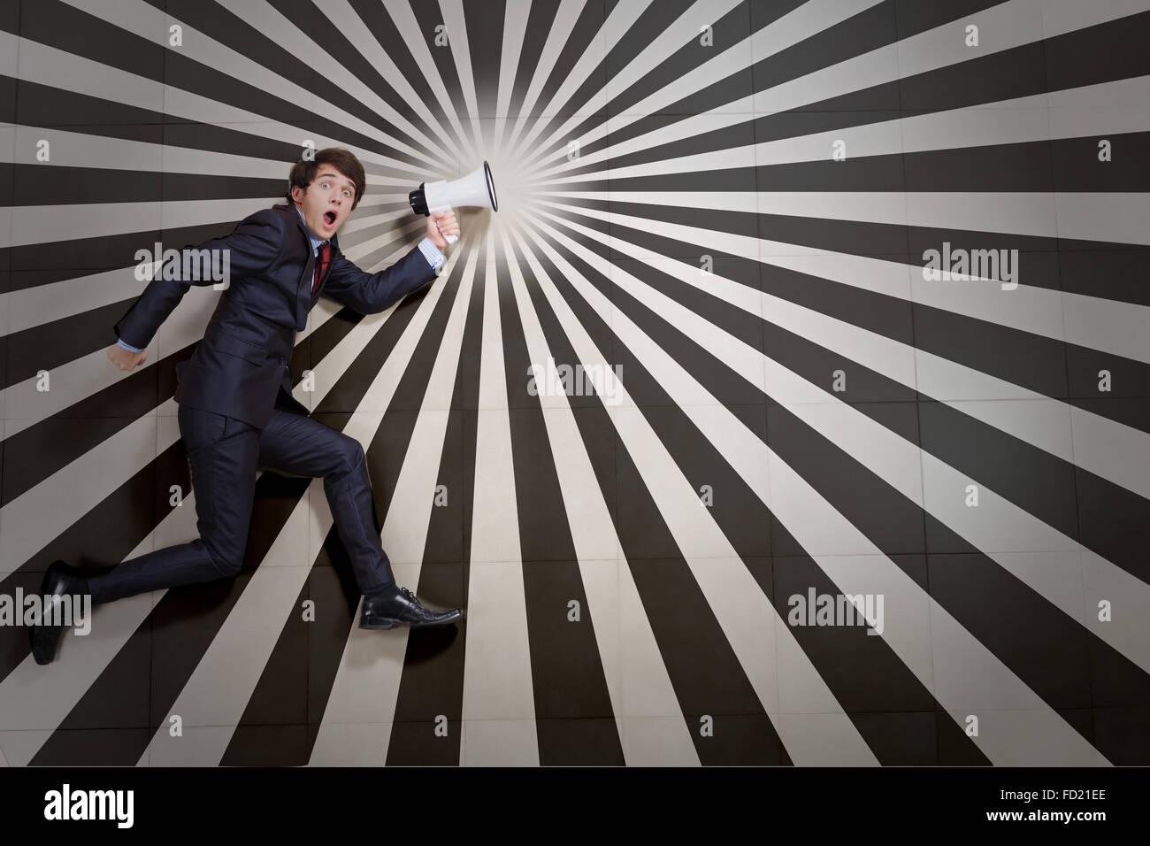 Young businessman running with megaphone in hand Stock Photo - Alamy