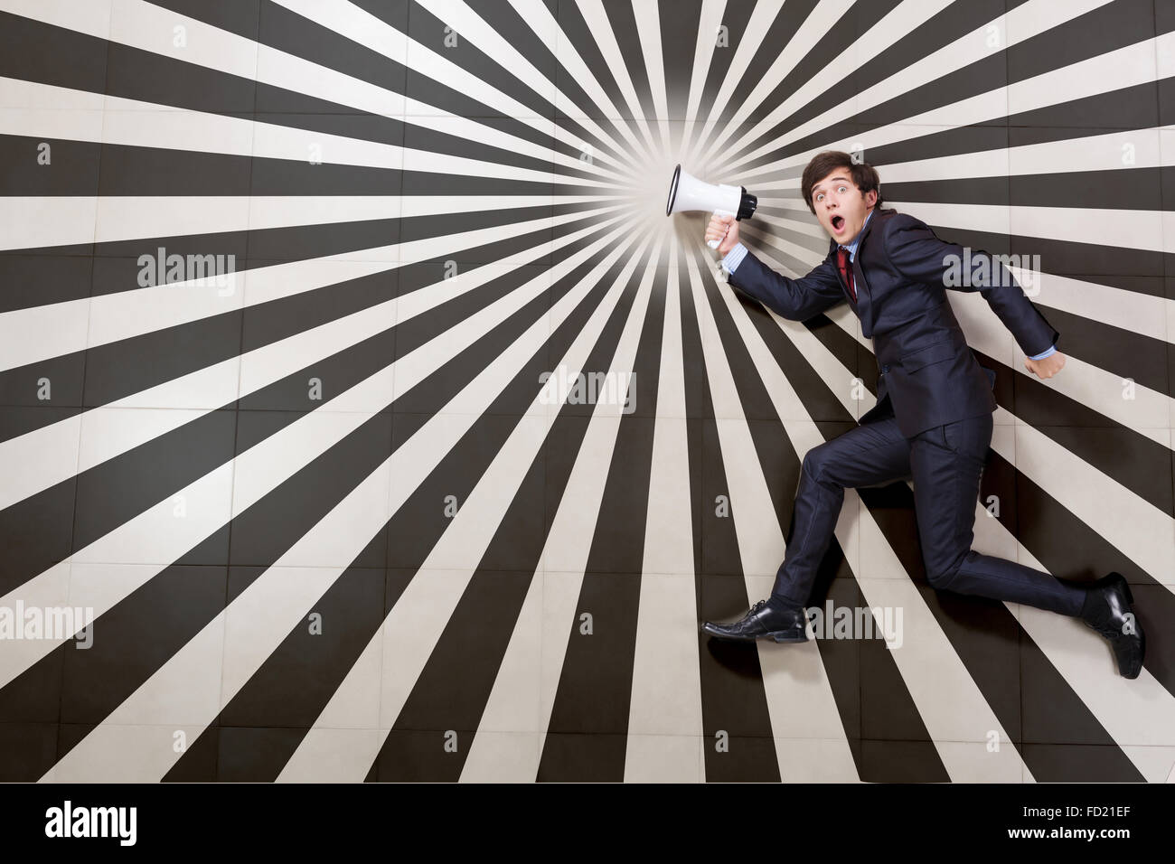 Young businessman running with megaphone in hand Stock Photo - Alamy