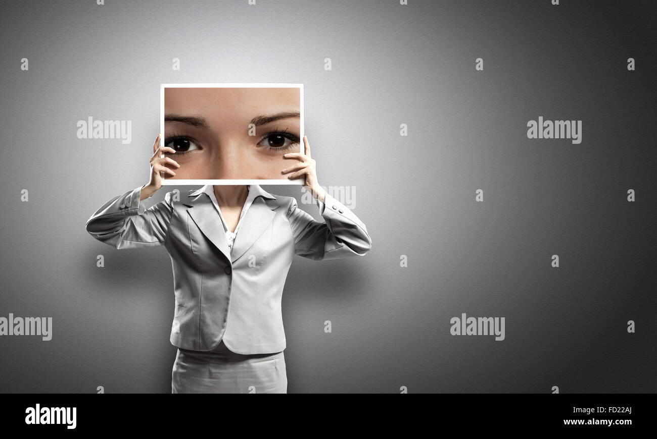 Businesswoman hiding face behind photo of eyes Stock Photo - Alamy