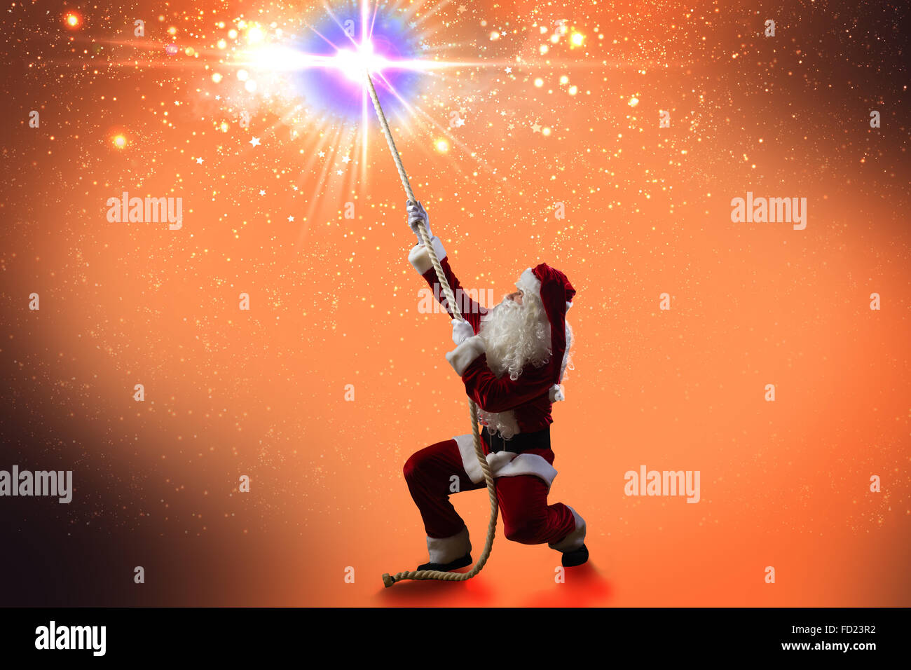 Santa Claus catching star in night sky with rope Stock Photo - Alamy