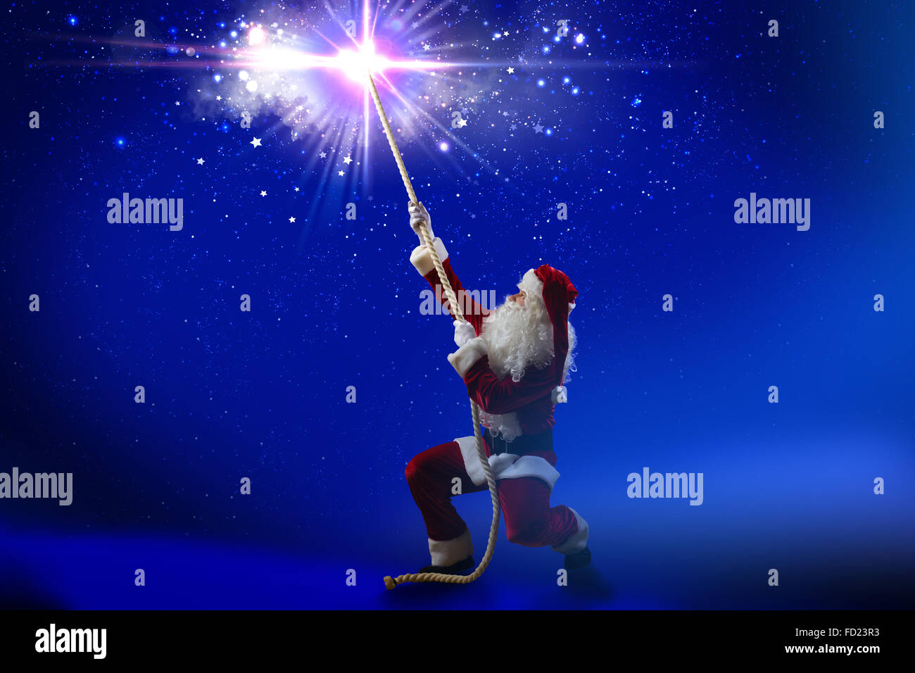 Santa Claus catching star in night sky with rope Stock Photo - Alamy