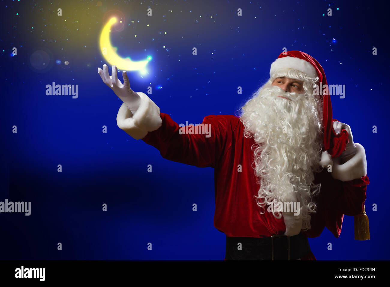 Santa claus holding moon in hi-res stock photography and images - Alamy