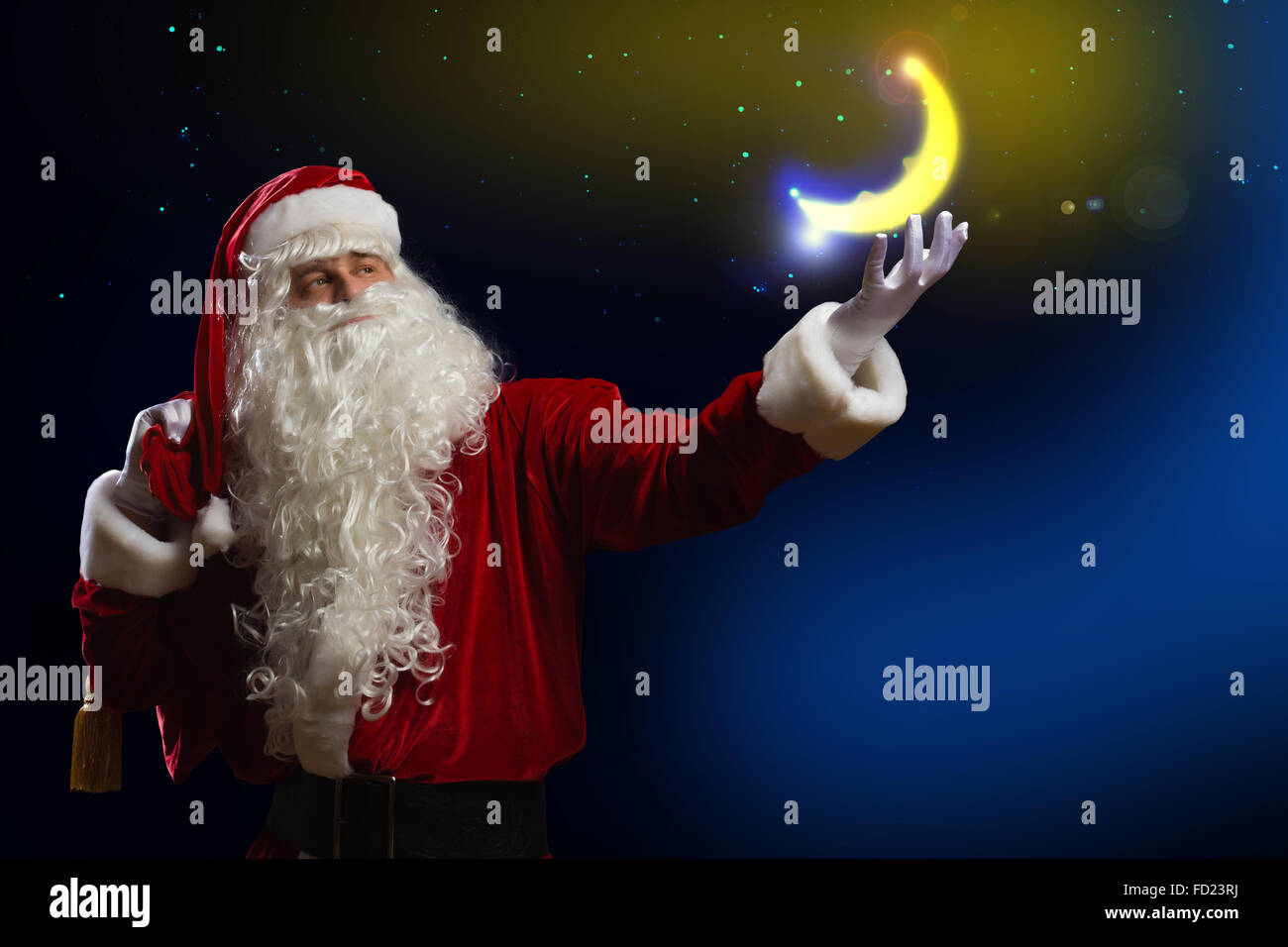 Santa claus holding moon in hi-res stock photography and images - Alamy