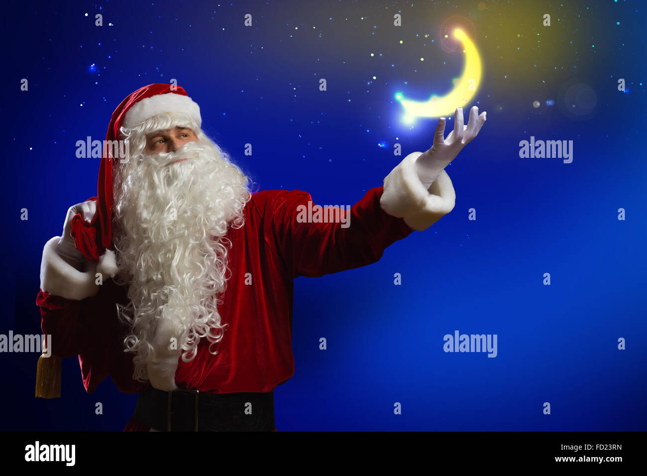 Santa claus holding moon in hi-res stock photography and images - Alamy