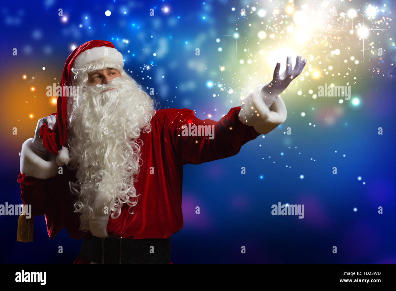 Santa Claus with gift bag behind shoulders Stock Photo - Alamy