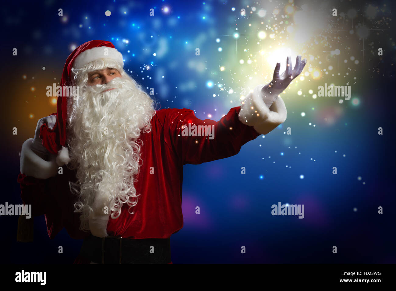 Santa Claus with gift bag behind shoulders Stock Photo - Alamy