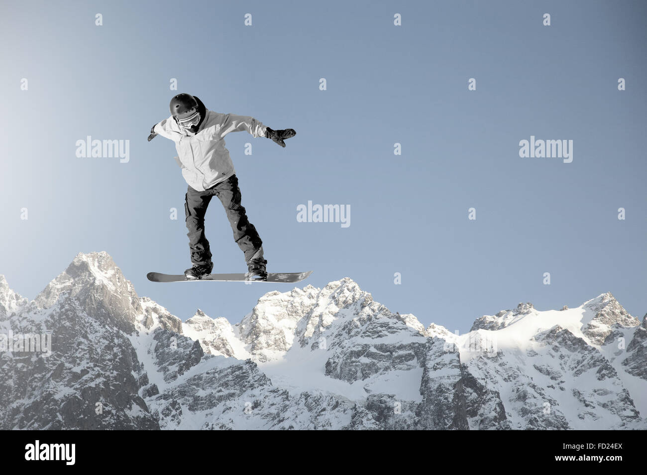 Snowboarder making high jump in clear blue sky Stock Photo - Alamy