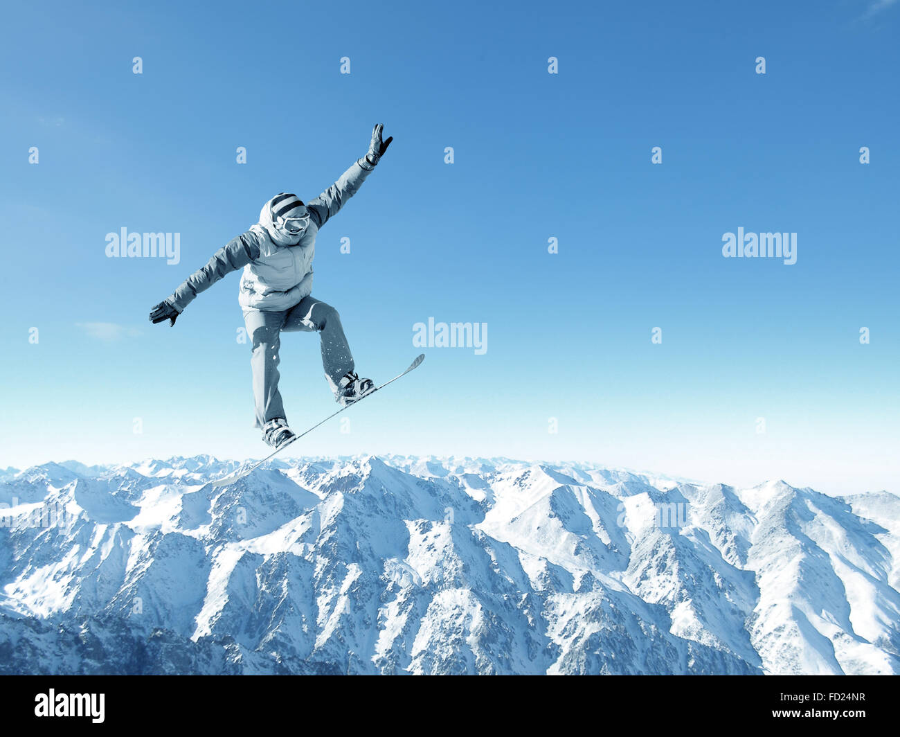 Snowboarder making high jump in clear blue sky Stock Photo - Alamy