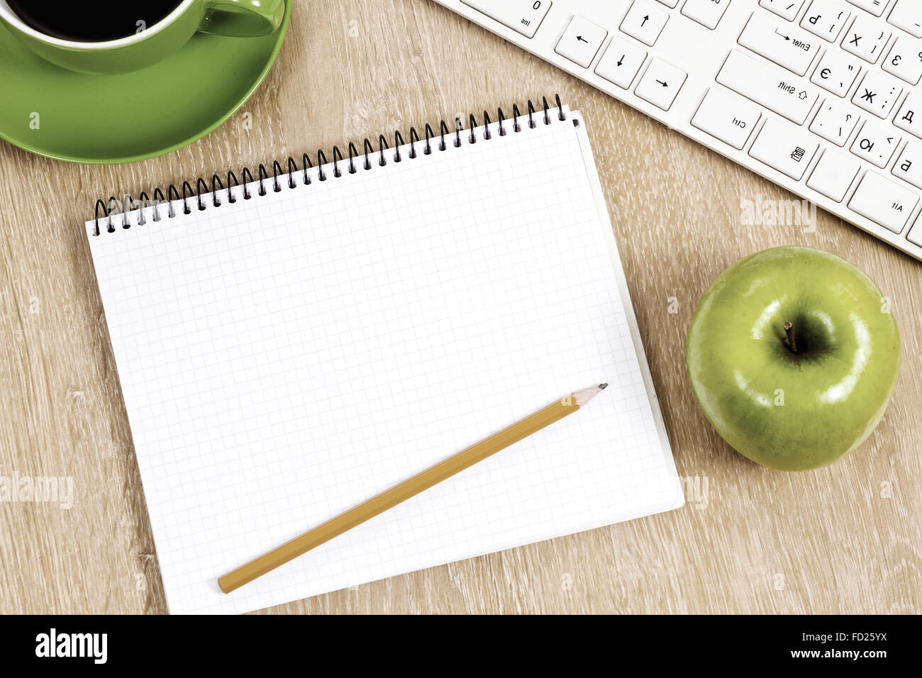 Keyboard cup of coffee and notepad at table Stock Photo - Alamy
