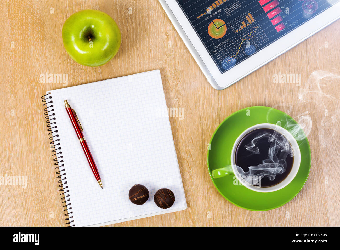 Tablet pc cup of coffee and notepad at table Stock Photo - Alamy
