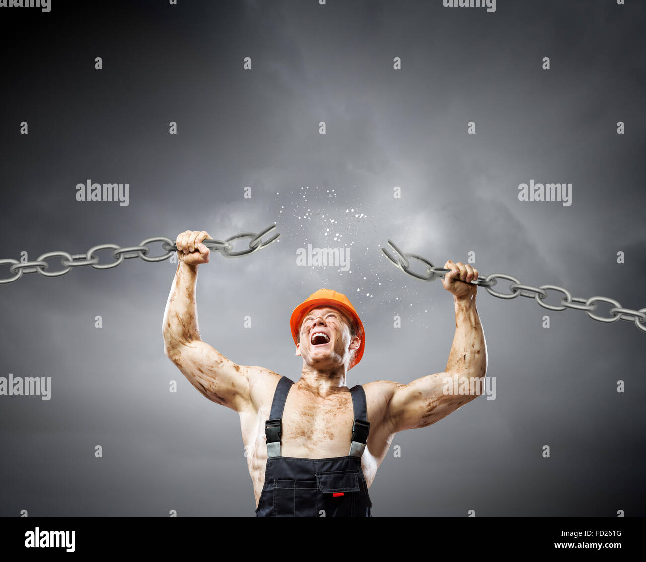 Strong man in uniform tearing metal chain with hands Stock Photo - Alamy