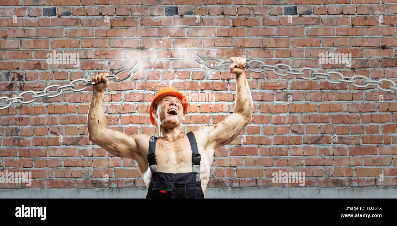 Strong man in uniform tearing metal chain with hands Stock Photo - Alamy