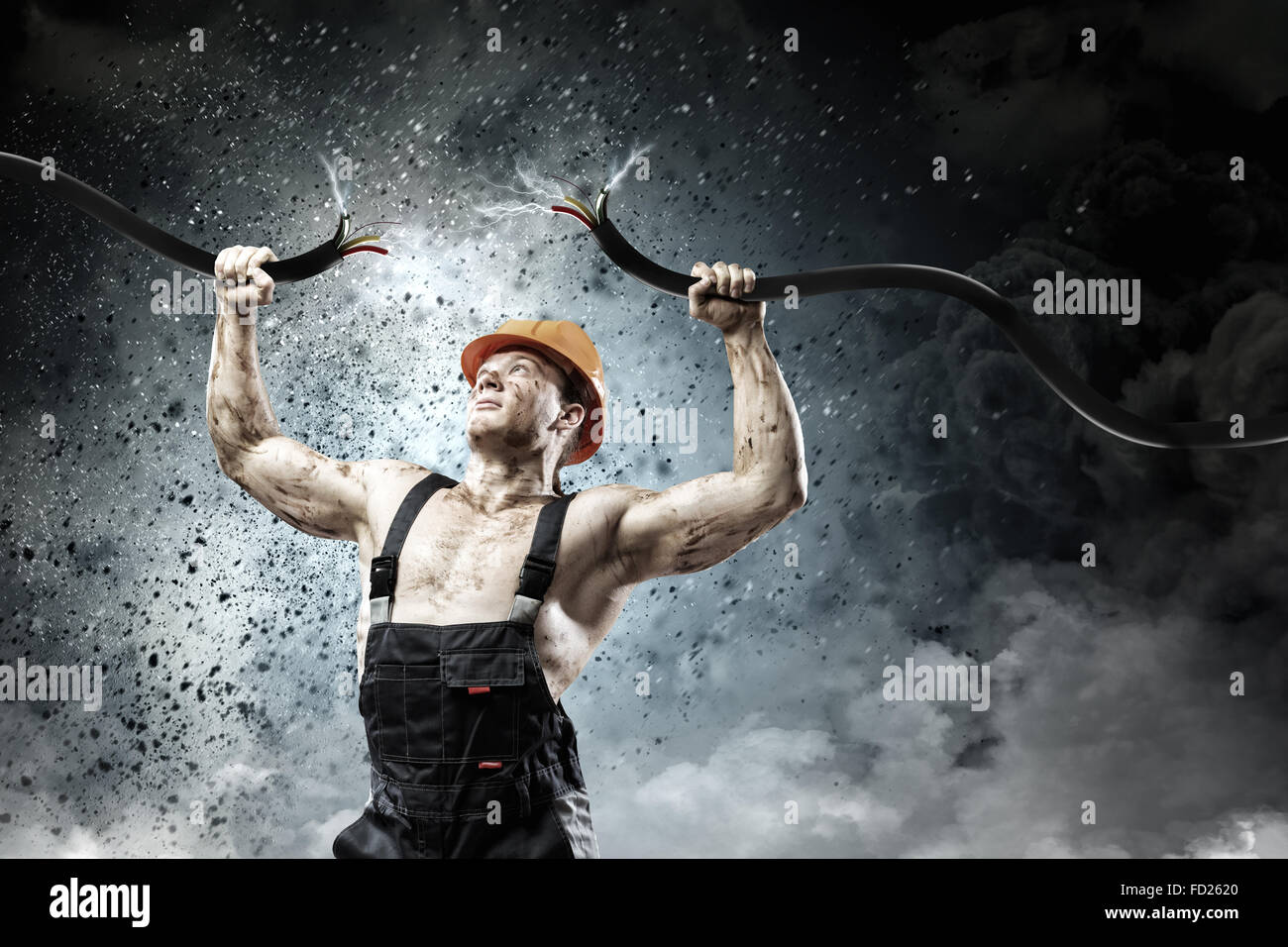 Strong man in uniform tearing electricity cable with hands Stock Photo ...
