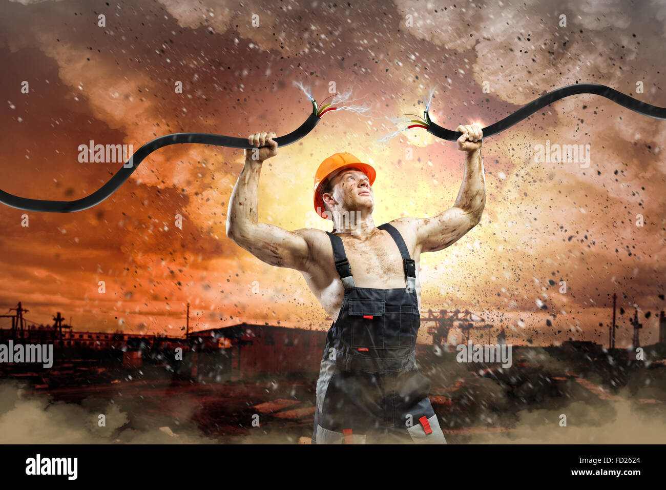 Strong man in uniform tearing electricity cable with hands Stock Photo ...