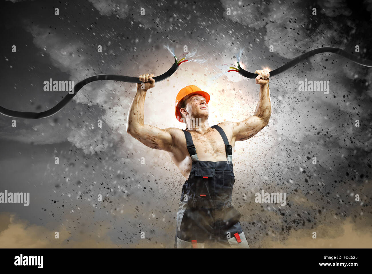 Strong man in uniform tearing electricity cable with hands Stock Photo ...