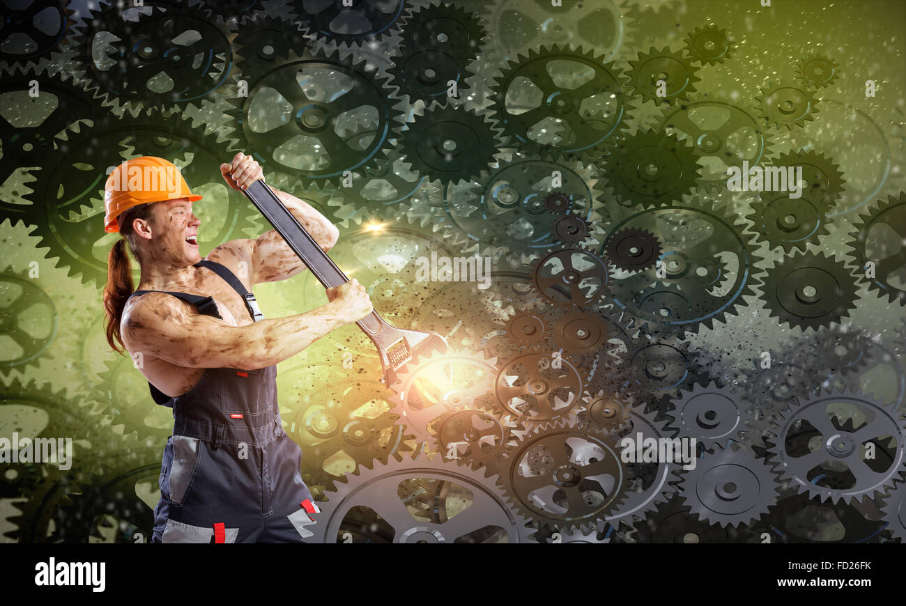 Strong man mechanic in uniform with spanner fixing mechanism Stock ...