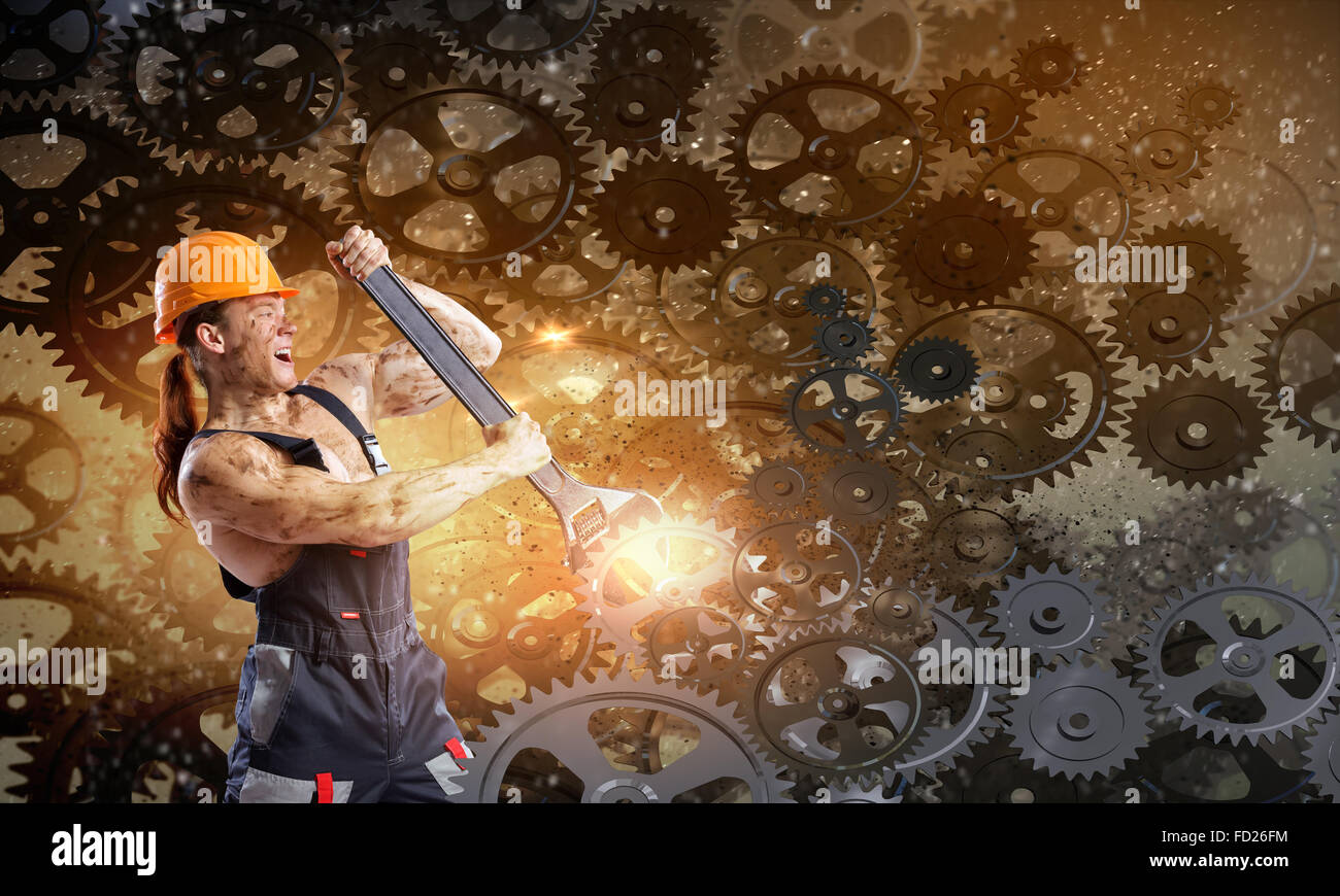 Strong man mechanic in uniform with spanner fixing mechanism Stock ...