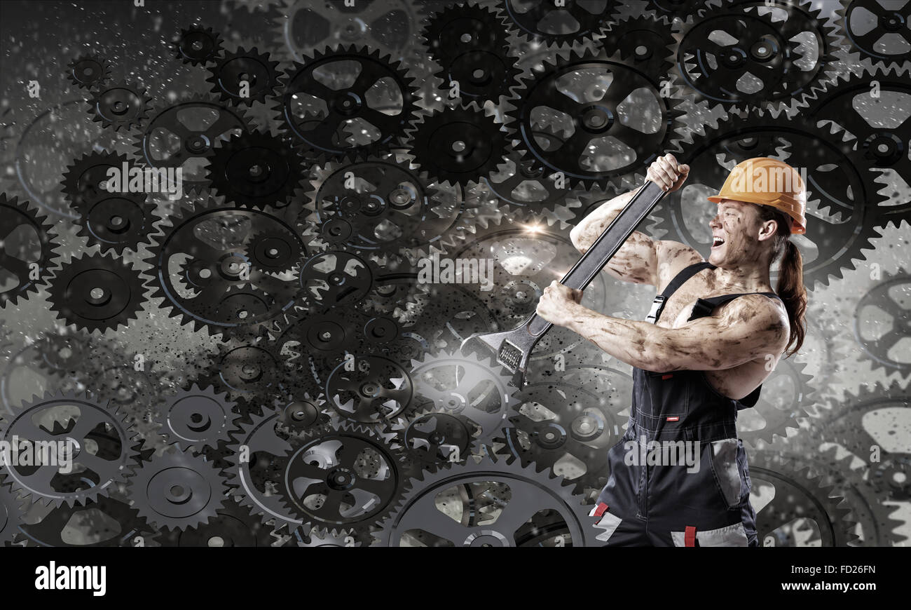 Strong man mechanic in uniform with spanner fixing mechanism Stock ...