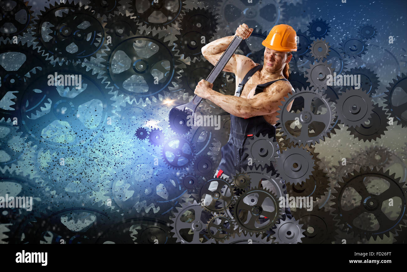 Strong man mechanic in uniform with spanner fixing mechanism Stock ...