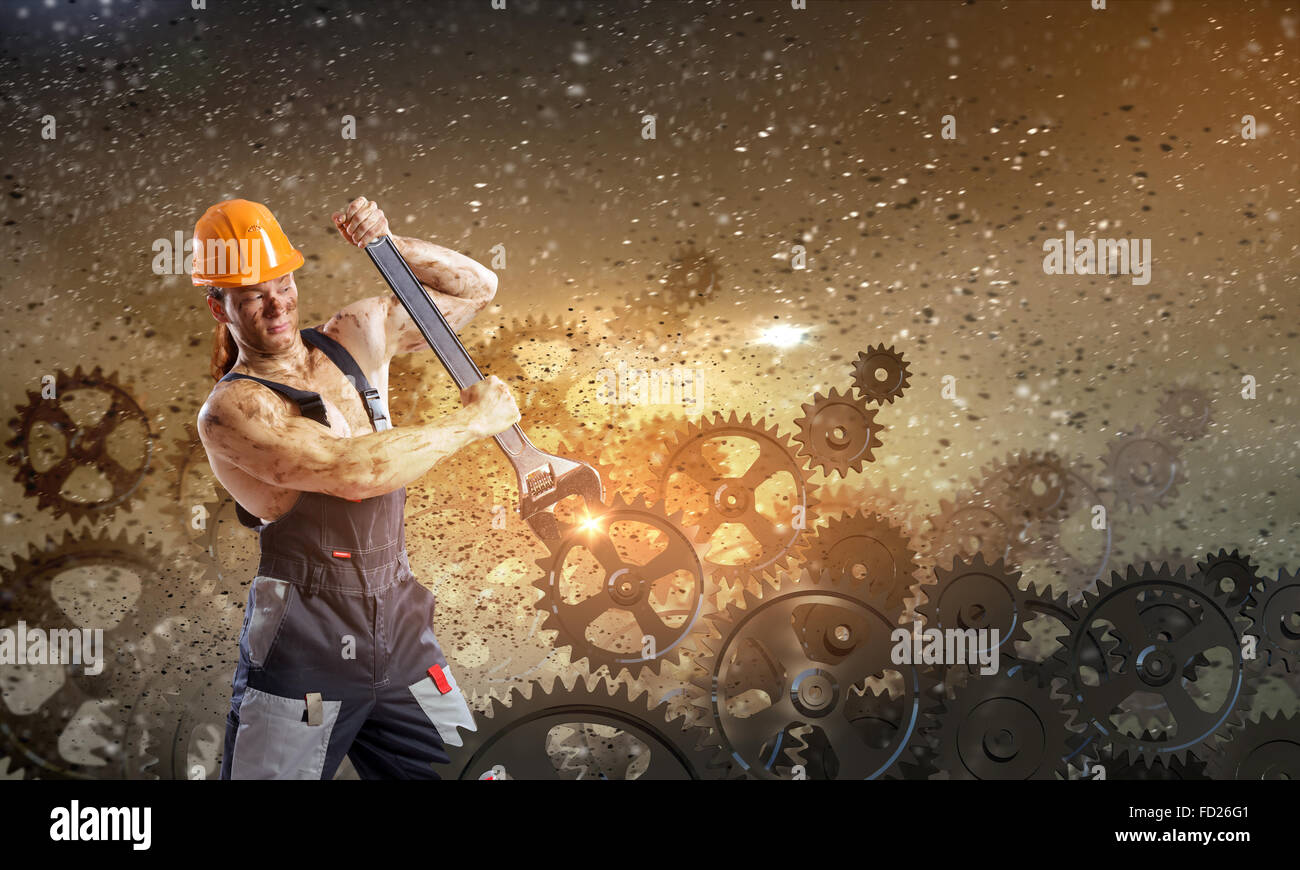 Strong man mechanic in uniform with spanner fixing mechanism Stock ...