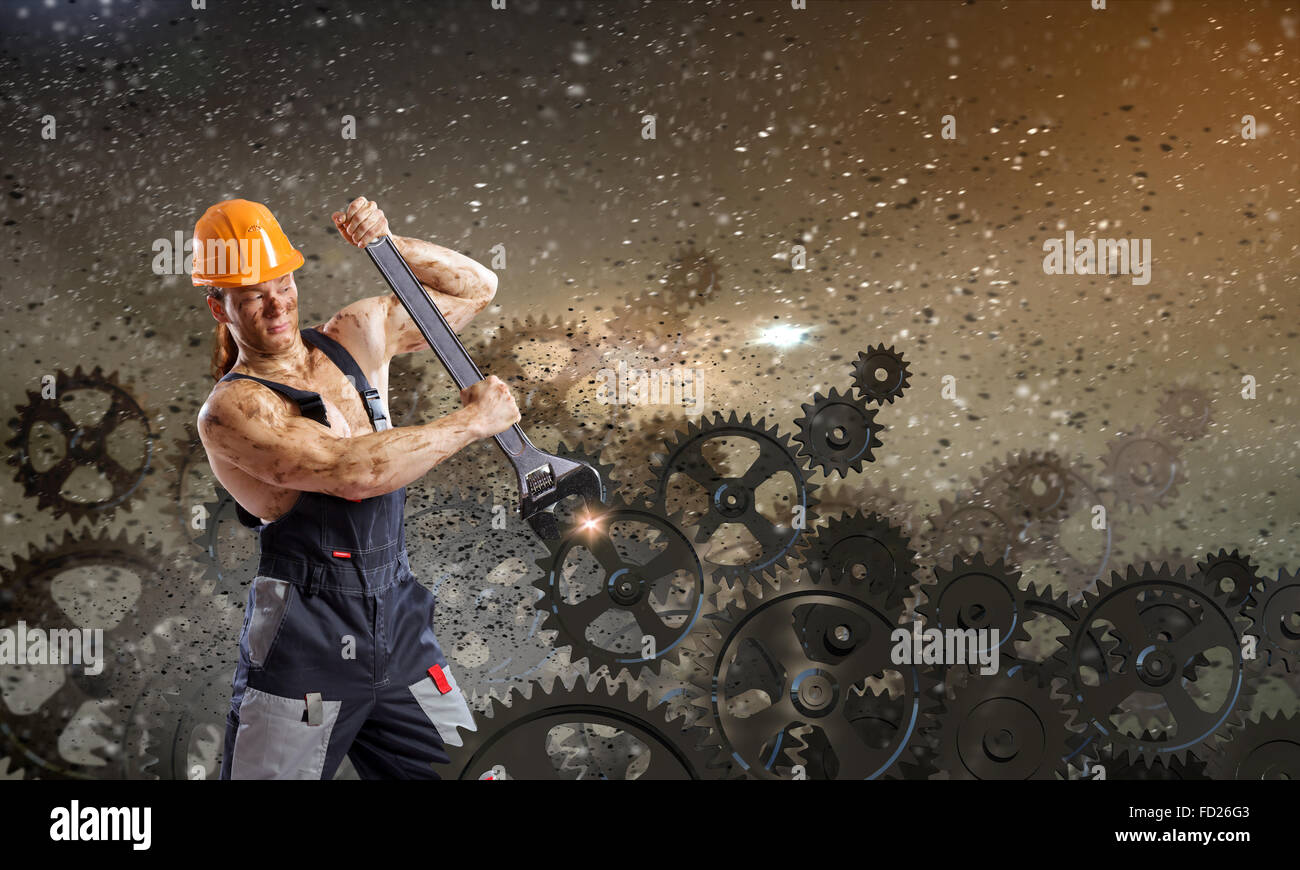 Strong man mechanic in uniform with spanner fixing mechanism Stock ...