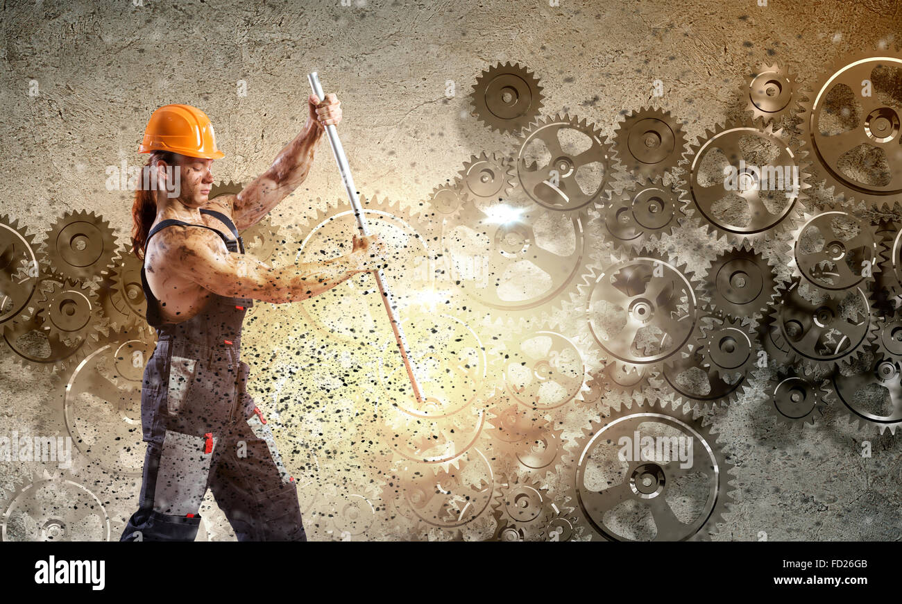 Strong man mechanic in uniform with spanner fixing mechanism Stock ...