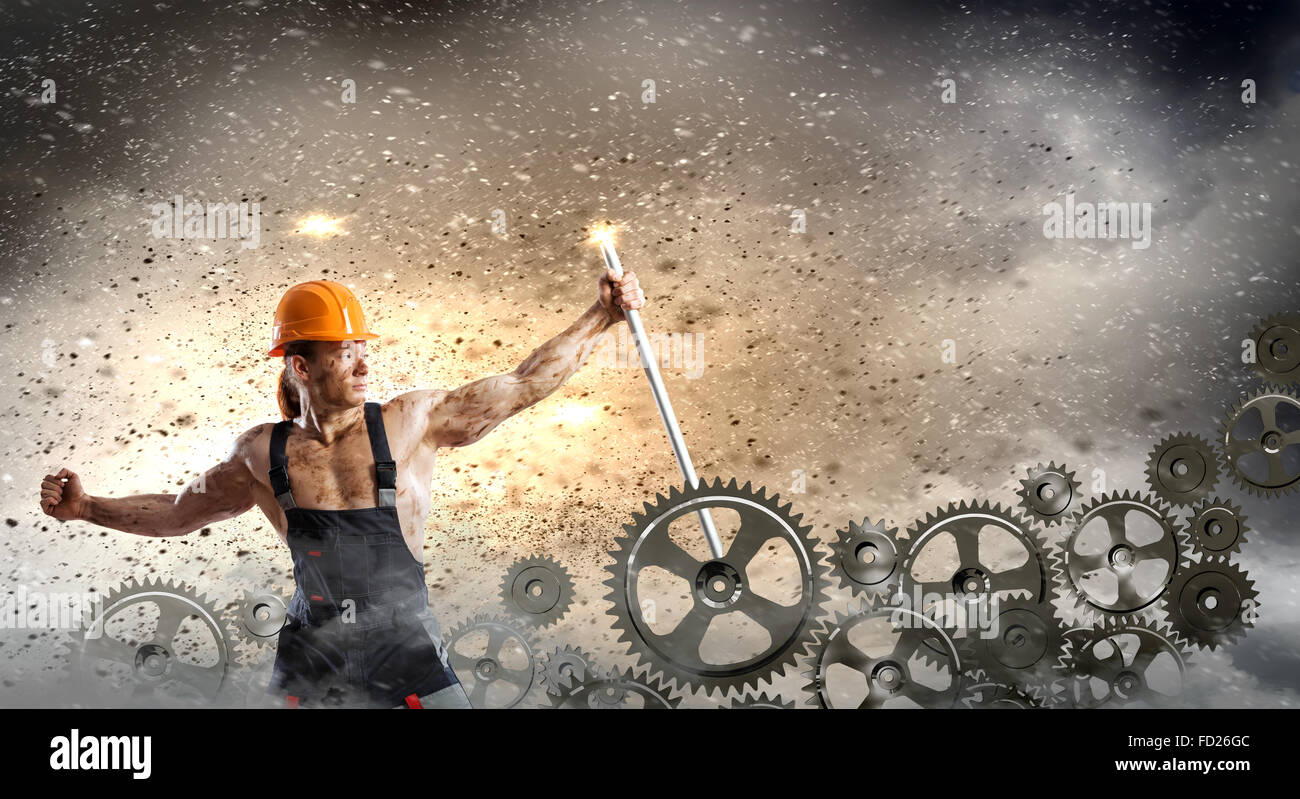 Strong man mechanic in uniform with spanner fixing mechanism Stock ...