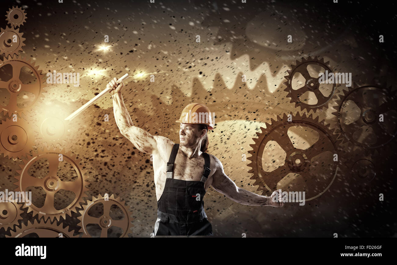 Strong man mechanic in uniform with spanner fixing mechanism Stock ...