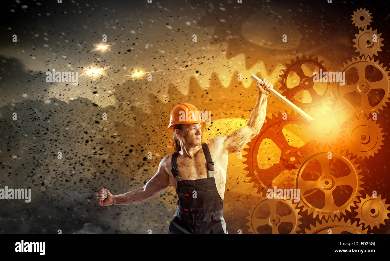 Strong man mechanic in uniform with spanner fixing mechanism Stock ...