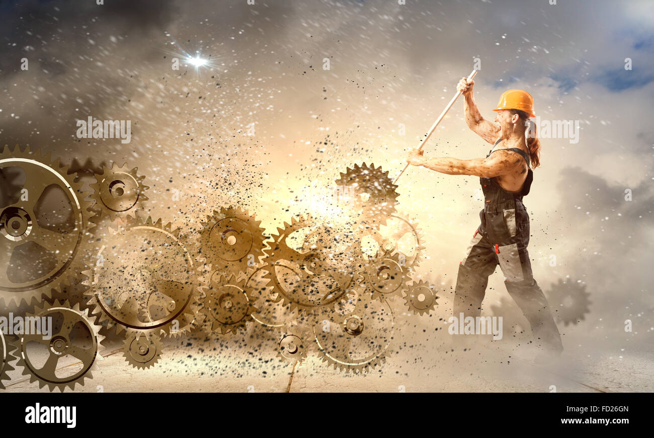 Strong man mechanic in uniform with spanner fixing mechanism Stock ...
